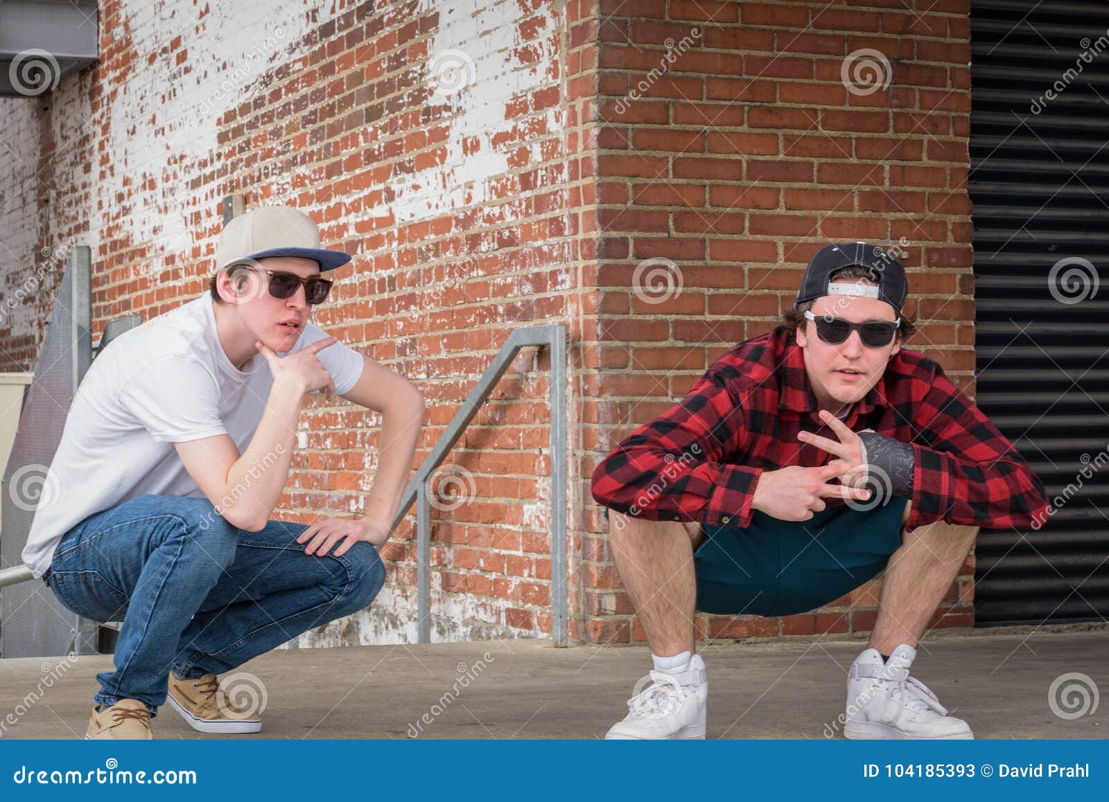 Two Millennials Men Posing by Brick Wall in City Stock Image - Image of ...