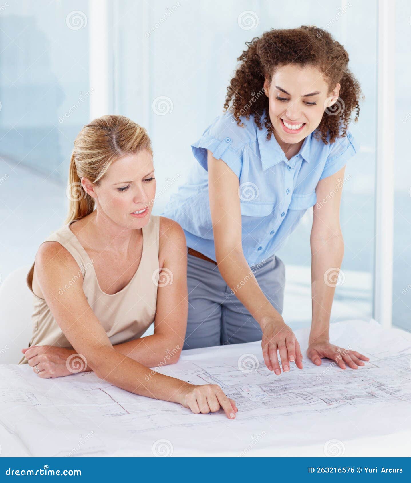 Two Minds are Better Than One. Two Architects Looking at Blueprints ...