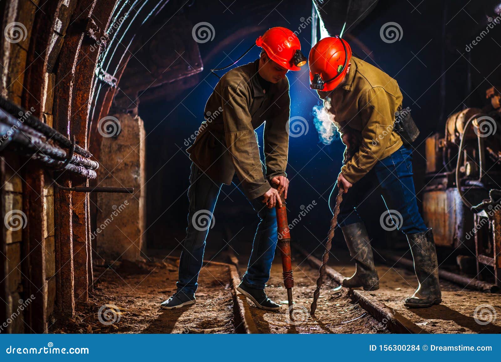 Two Miners In The Mine. Girls In Red Helmets And Lanterns In A Coal ...