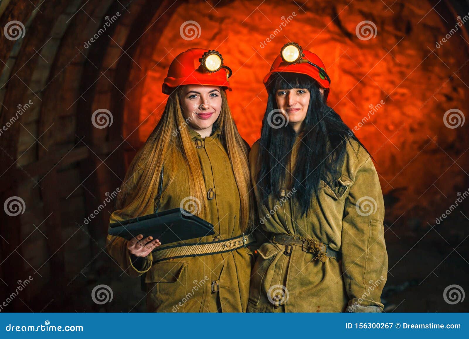 Two Miners In The Mine. Girls In Red Helmets And Lanterns In A Coal ...