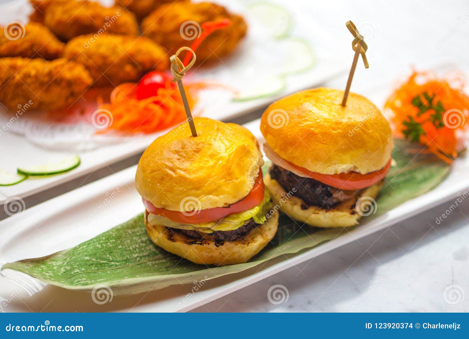 Two Mini Burgers on a Banana Leaf Stock Photo - Image of meat, sliders ...
