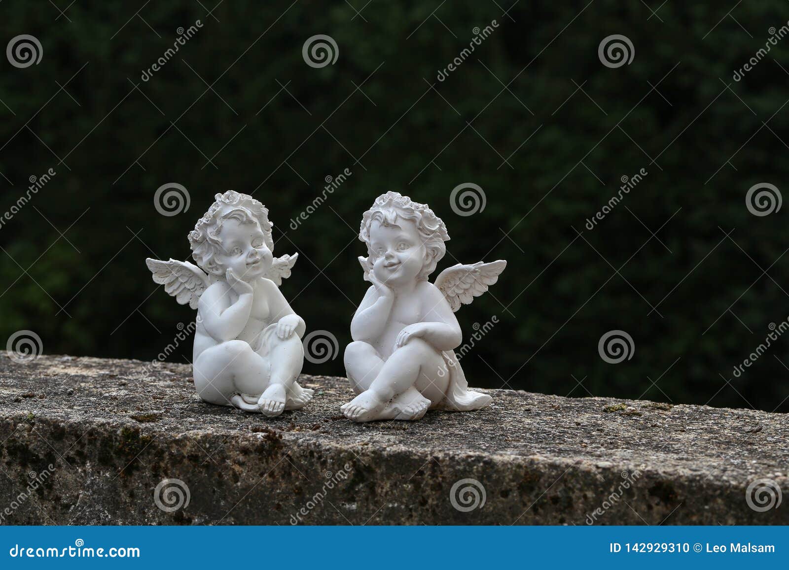 Two Miniature Angels on a Stone Wall Stock Photo - Image of angels ...