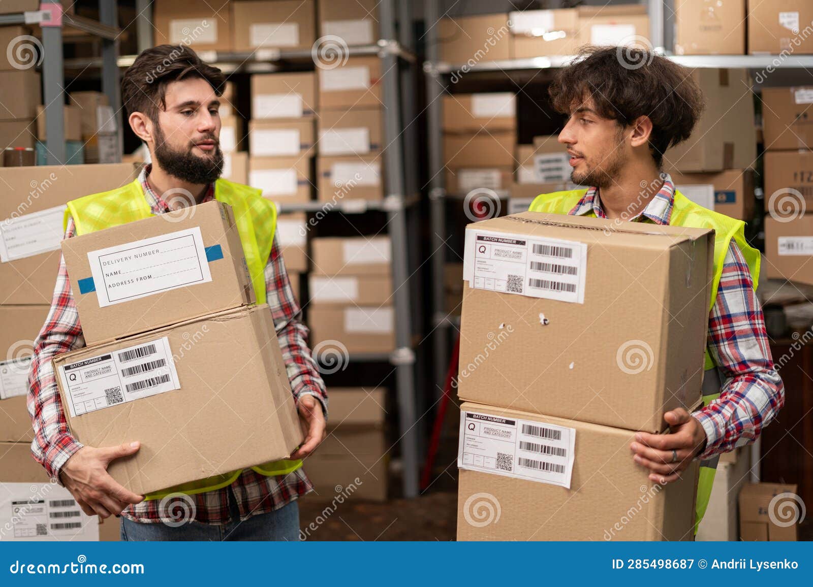 Two Mixed Race Workers in a Warehouse in the Logistics Sector ...
