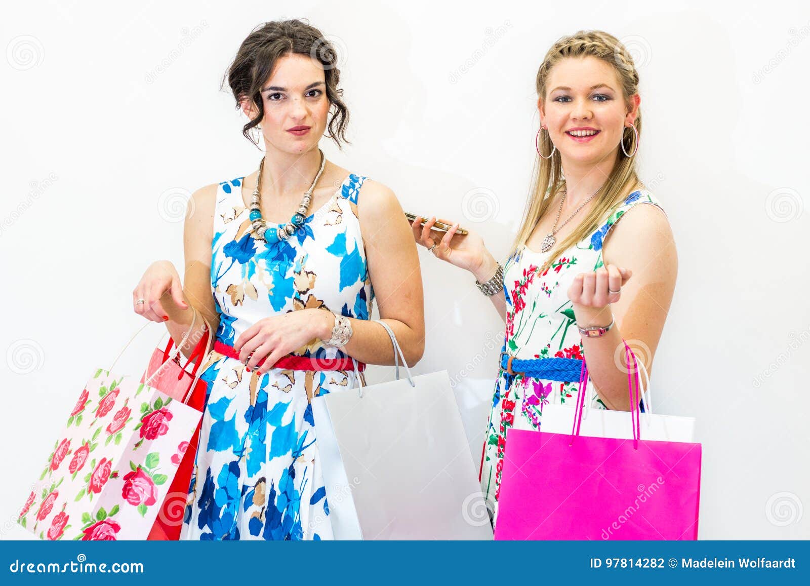 Two Models Standing with Shopping Bags and Smart Phone Stock Photo ...