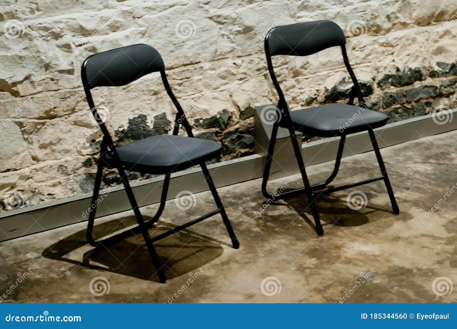Two Modern Black Chairs in a Strong Rock Prison Cell Stock Photo ...
