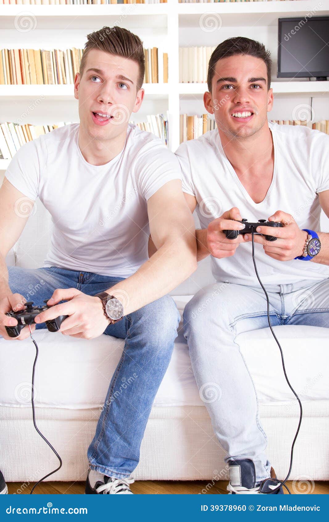 Two Modern Guys Playing Computer Game Holding Controllers Stock Photo ...