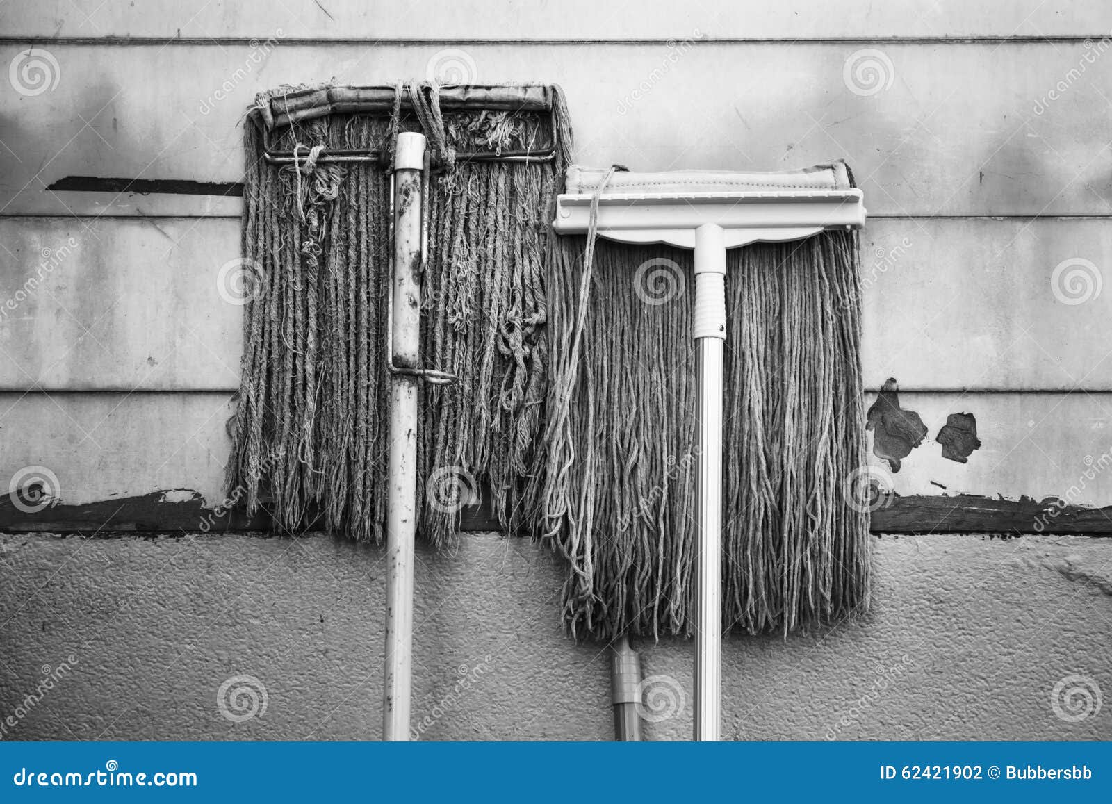 Two Mop Old Resting Against the Wall. Stock Photo - Image of closeup ...