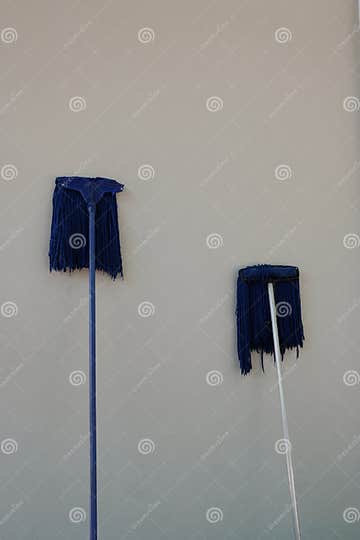 Two Mops Leaning Against the Wall Stock Image - Image of closeup ...
