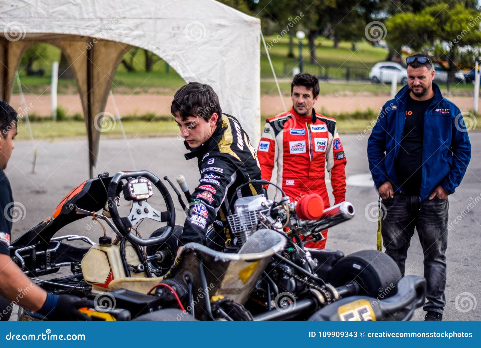 Two Motorcycle Racers Standing In Front Of Motorcycles Picture. Image ...