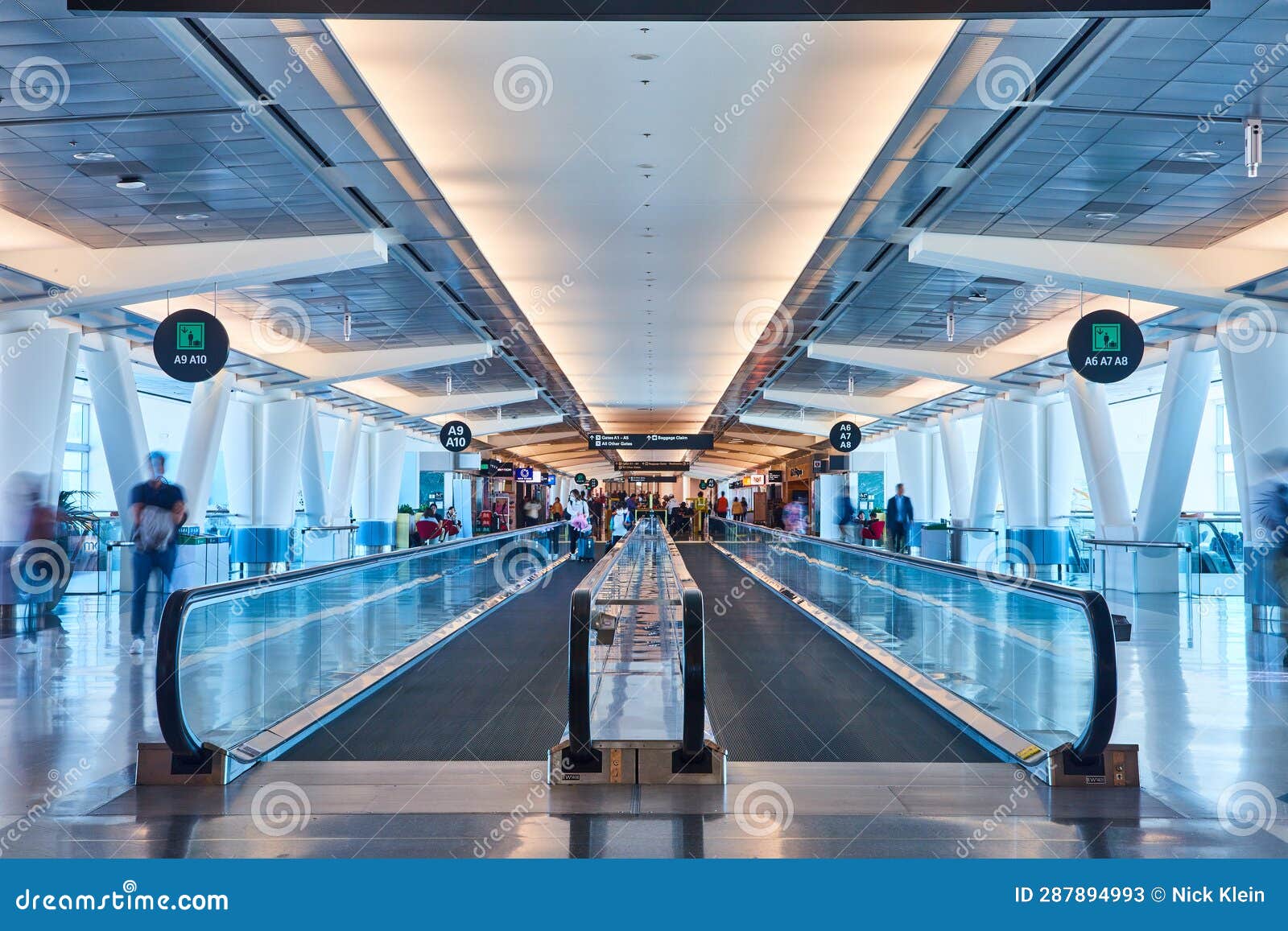 Two Moving Walkways Side by Side with People Stepping on Far End in ...