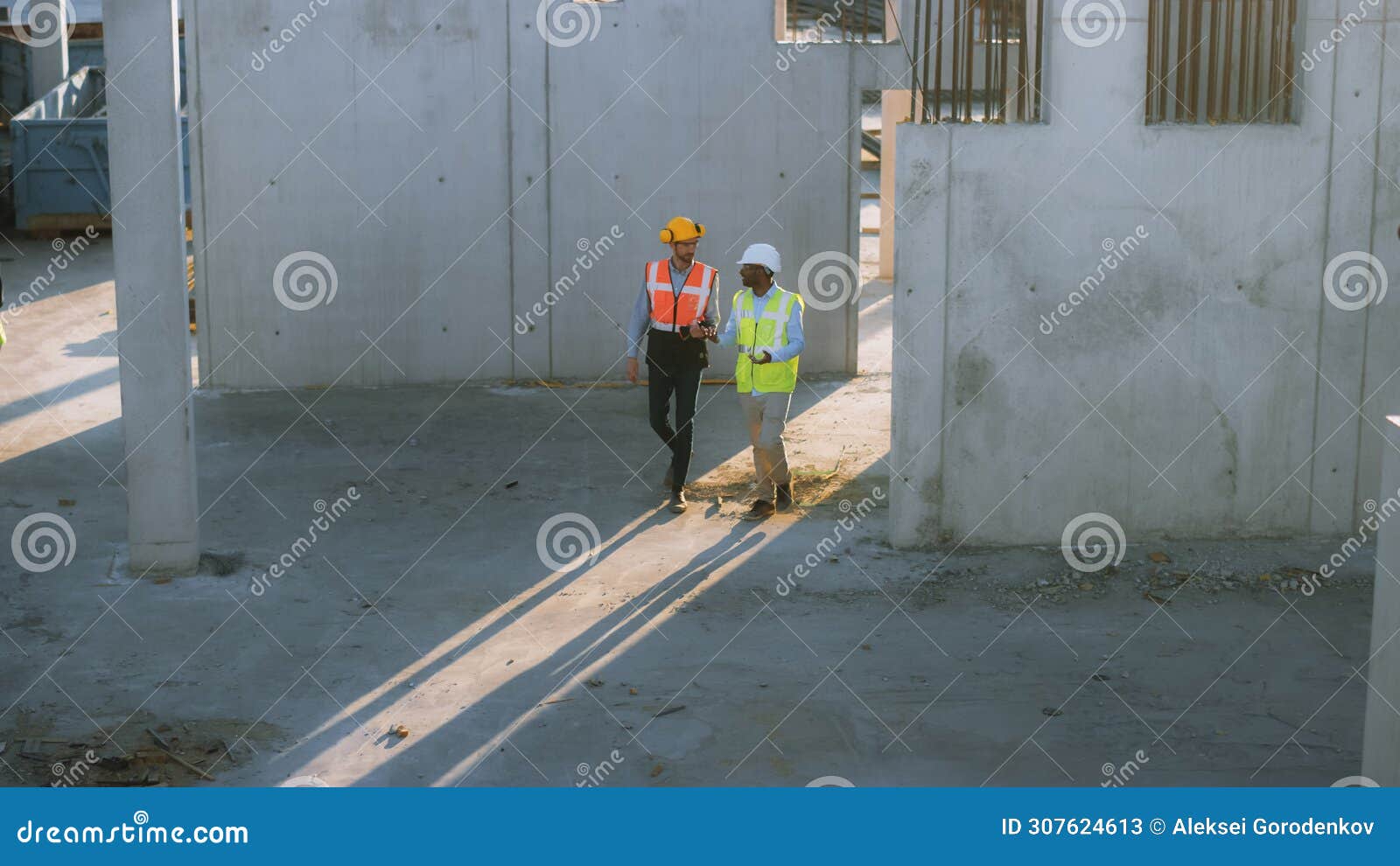 Two Multicultural General Contractors Taking a Walk through ...