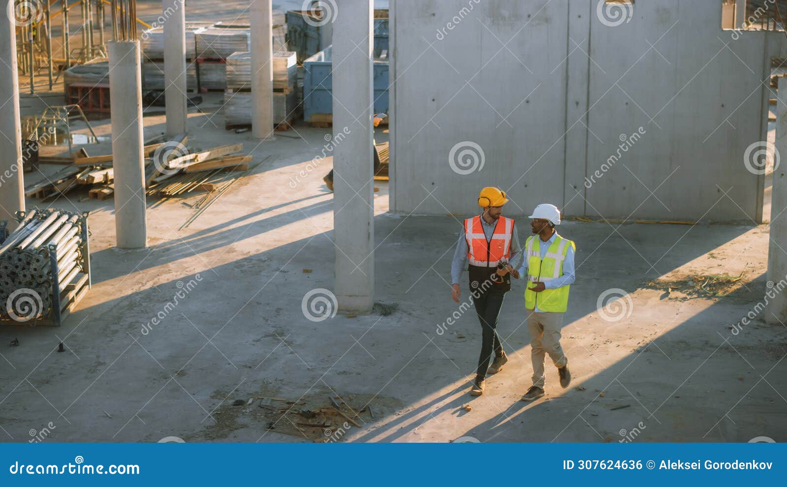 Two Multicultural General Contractors Taking a Walk through ...