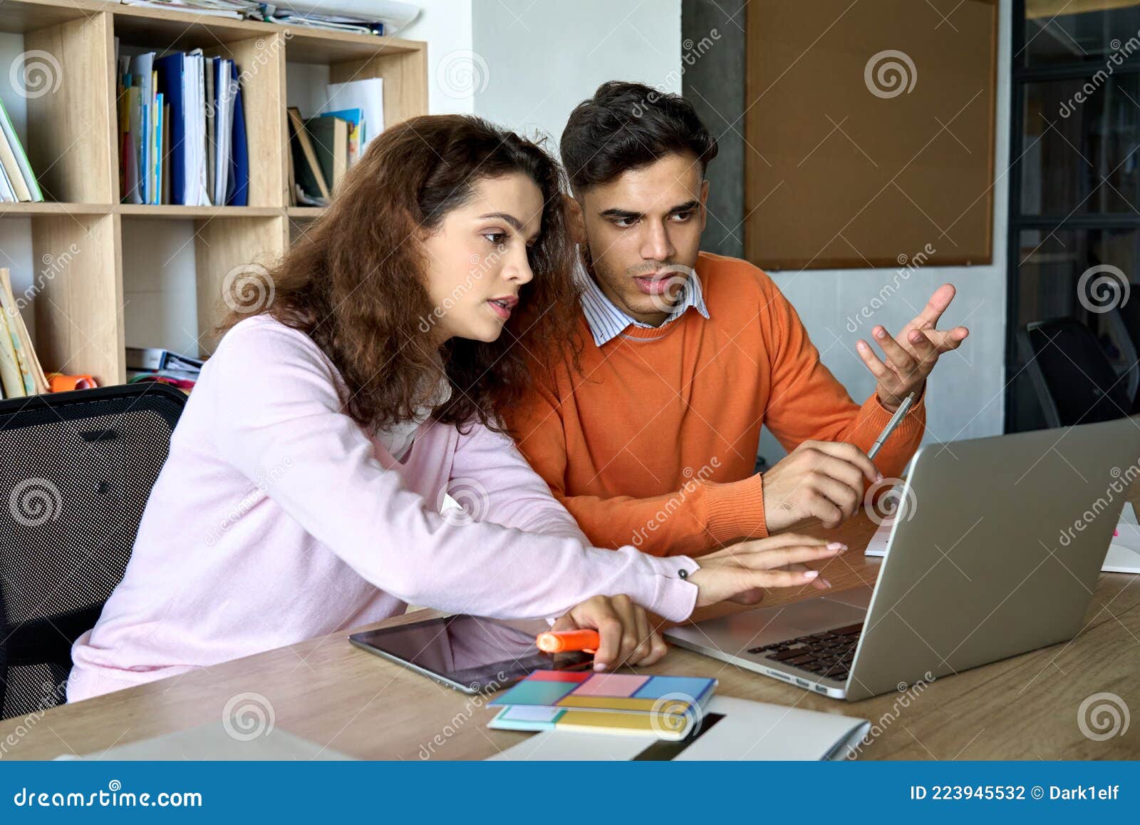 Two Multicultural Students Using Laptop Sitting Together at Desk in ...