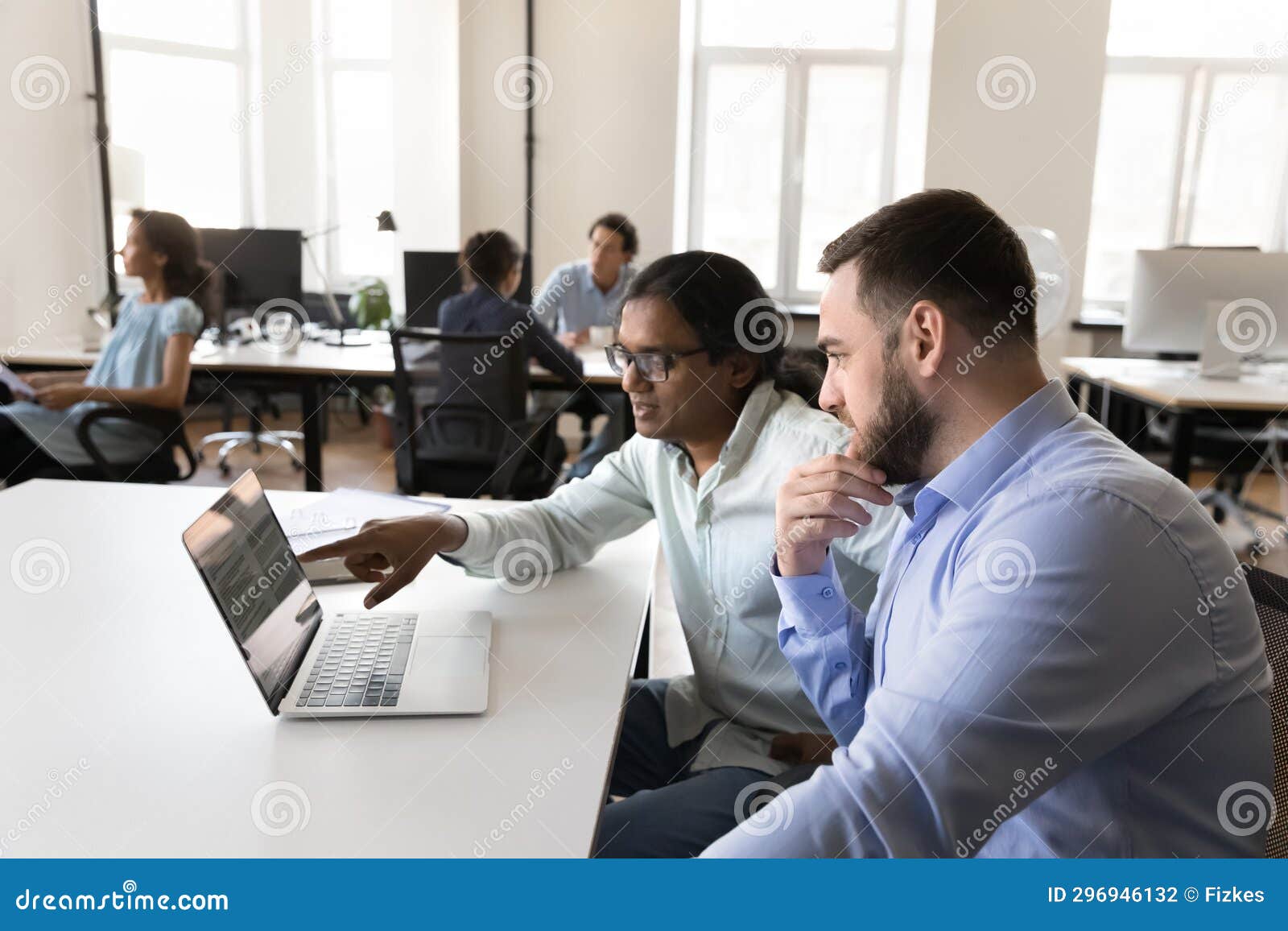 Two Multiethnic Employees Watching Project Presentation on Laptop Stock ...