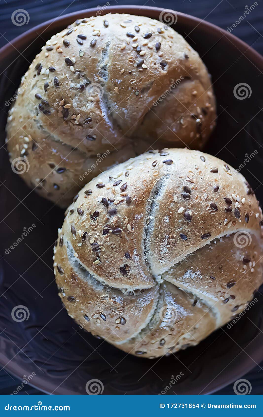 Two Multigrain Buns with Sesame Seeds and Flaxseed on a Brown Plate ...