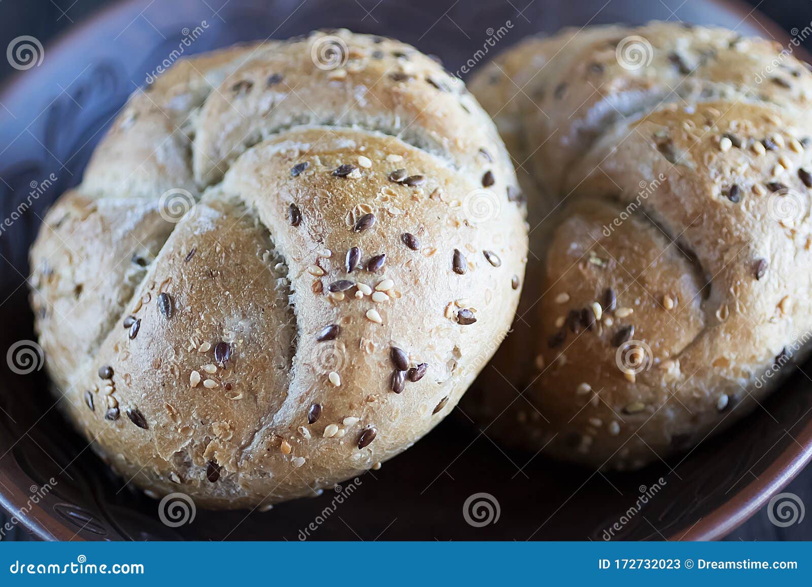 Two Multigrain Buns with Sesame Seeds and Flaxseed on a Brown Plate ...