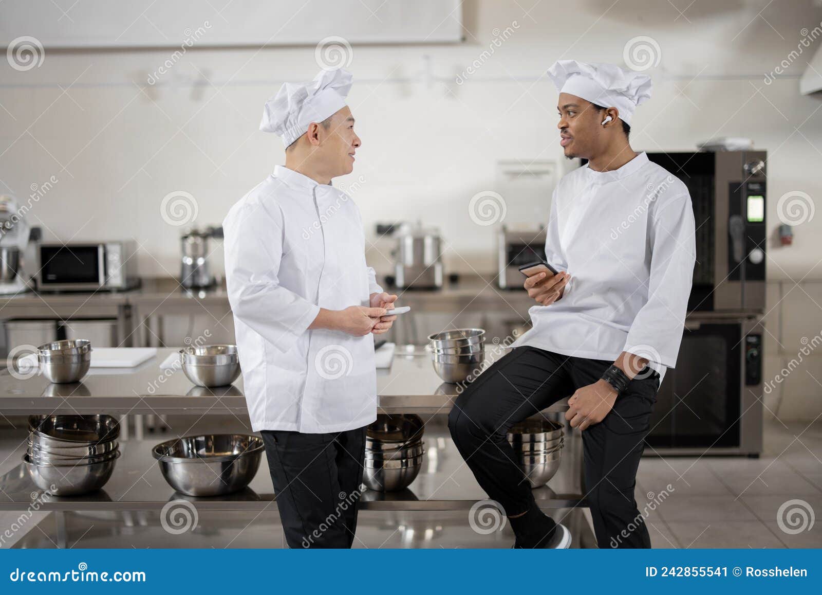 Two Multiracial Chef Cooks Talking during a Break at the Professional ...