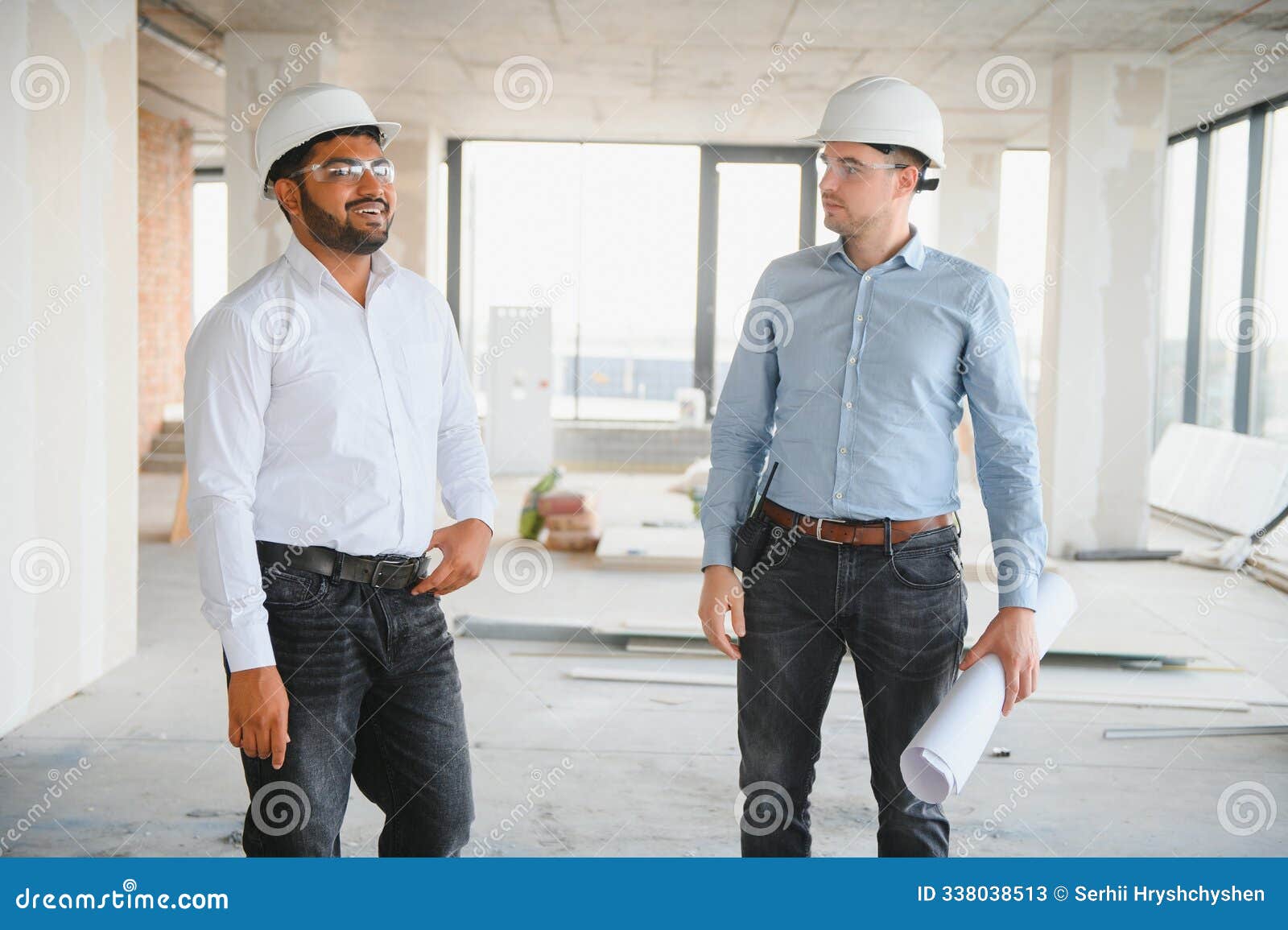 Two Multiracial Engineer Working at Site of a Large Building Project ...