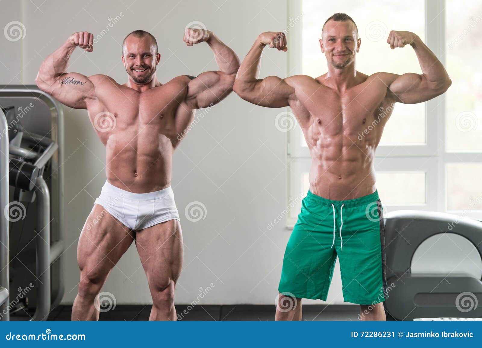 Two Muscular Men Flexing Muscles In Gym Stock Image Image Of Person