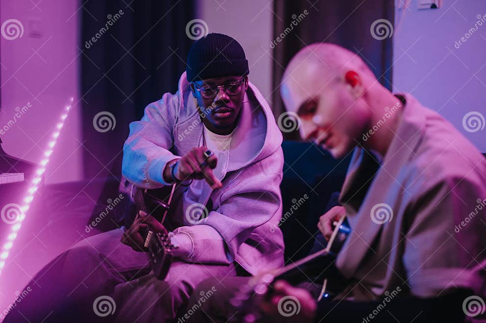 Two Musicians Collaborating and Sharing Ideas in a Creative Studio ...