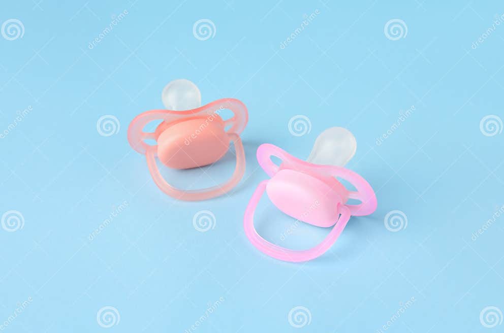 Two New Baby Pacifiers on Light Blue Background Stock Image - Image of ...