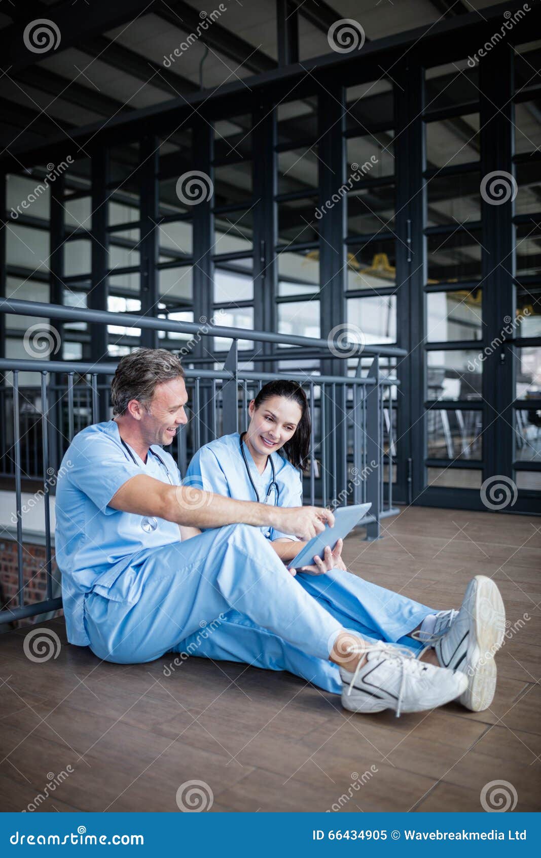 Two Nurses Sitting on Floor and Talking Stock Image - Image of ...