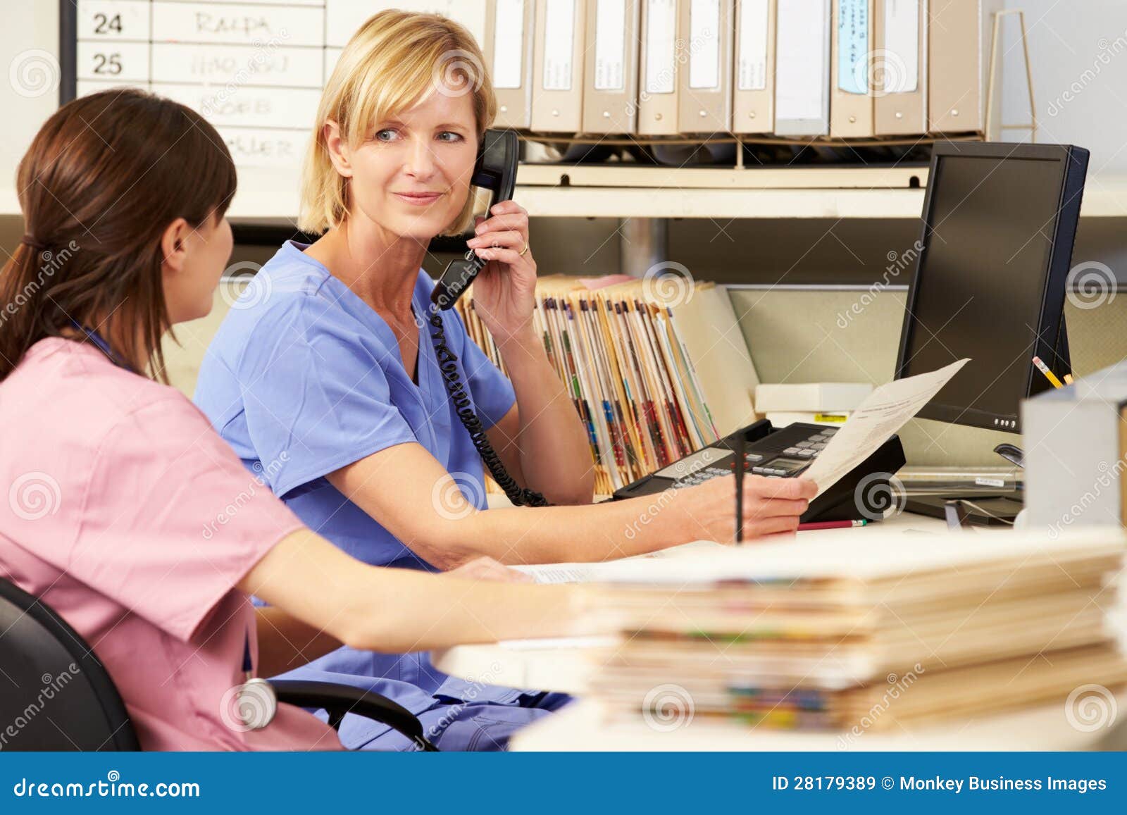 Two Nurses Working at Nurses Station Stock Image - Image of female ...