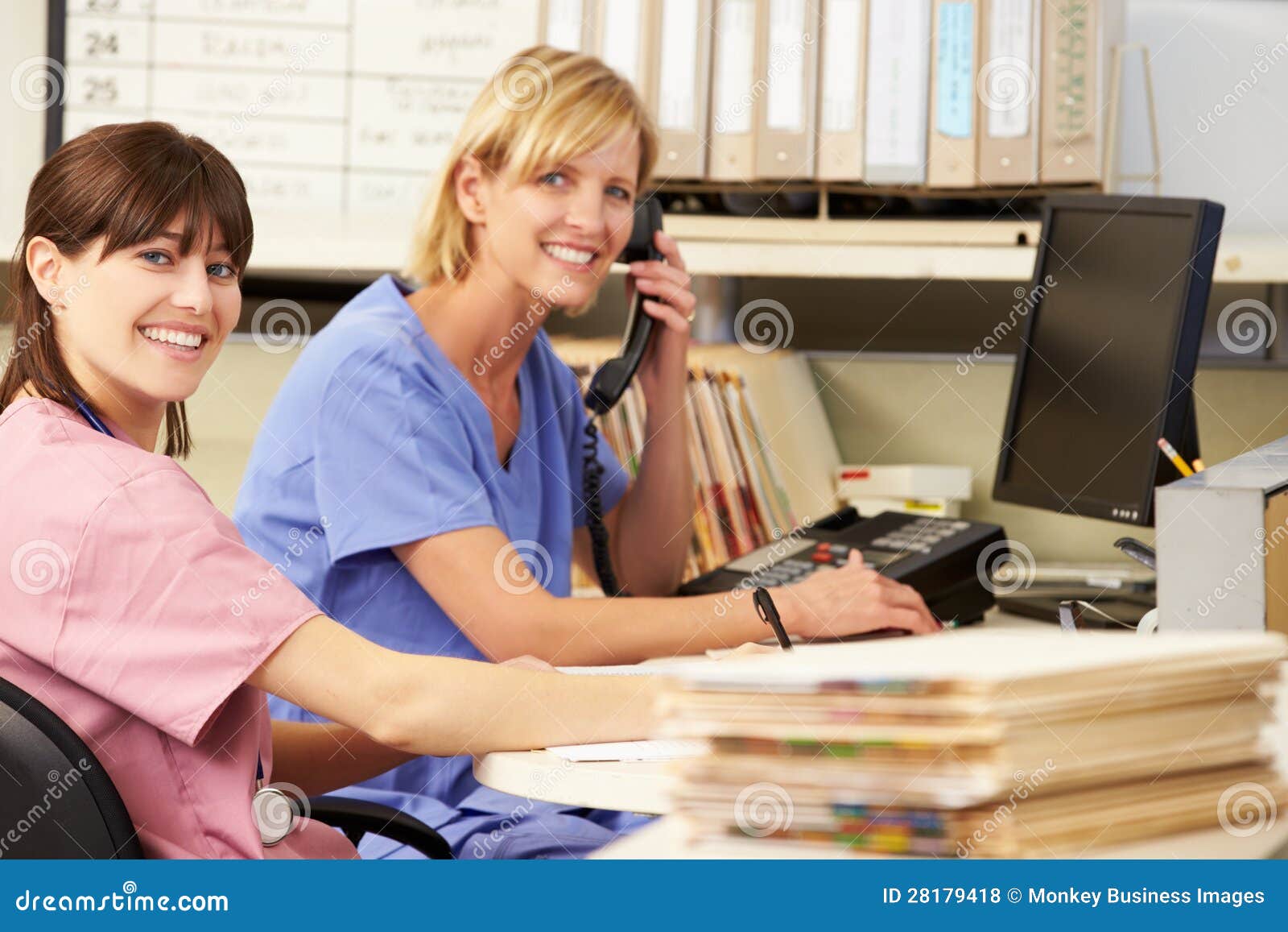 Two Nurses Working at Nurses Station Stock Photo - Image of person ...