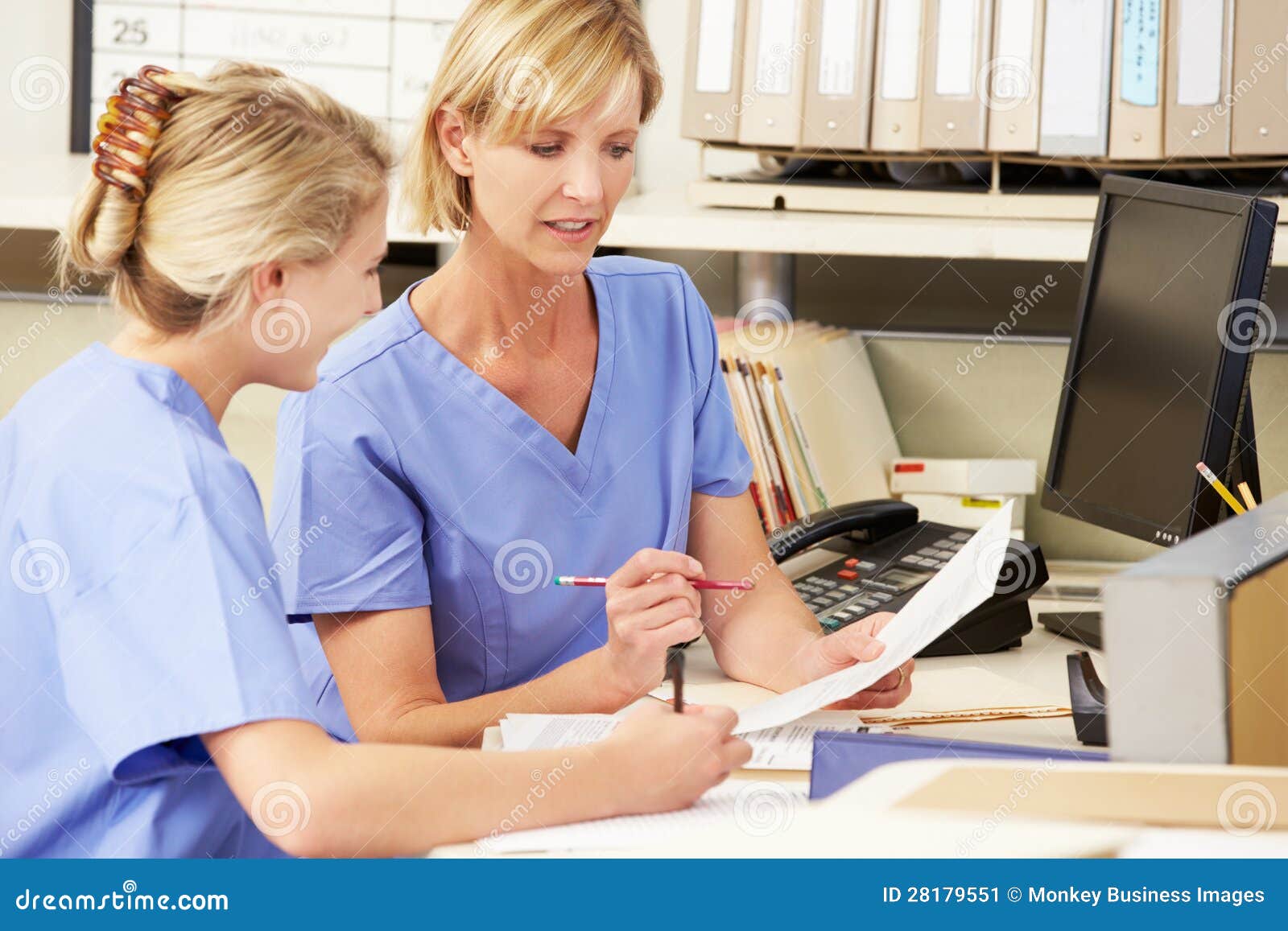 Two Nurses Working at Nurses Station Stock Image - Image of friendly ...