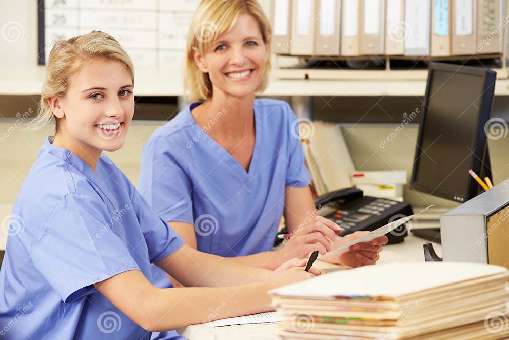 Two Nurses Working at Nurses Station Stock Image - Image of camera ...