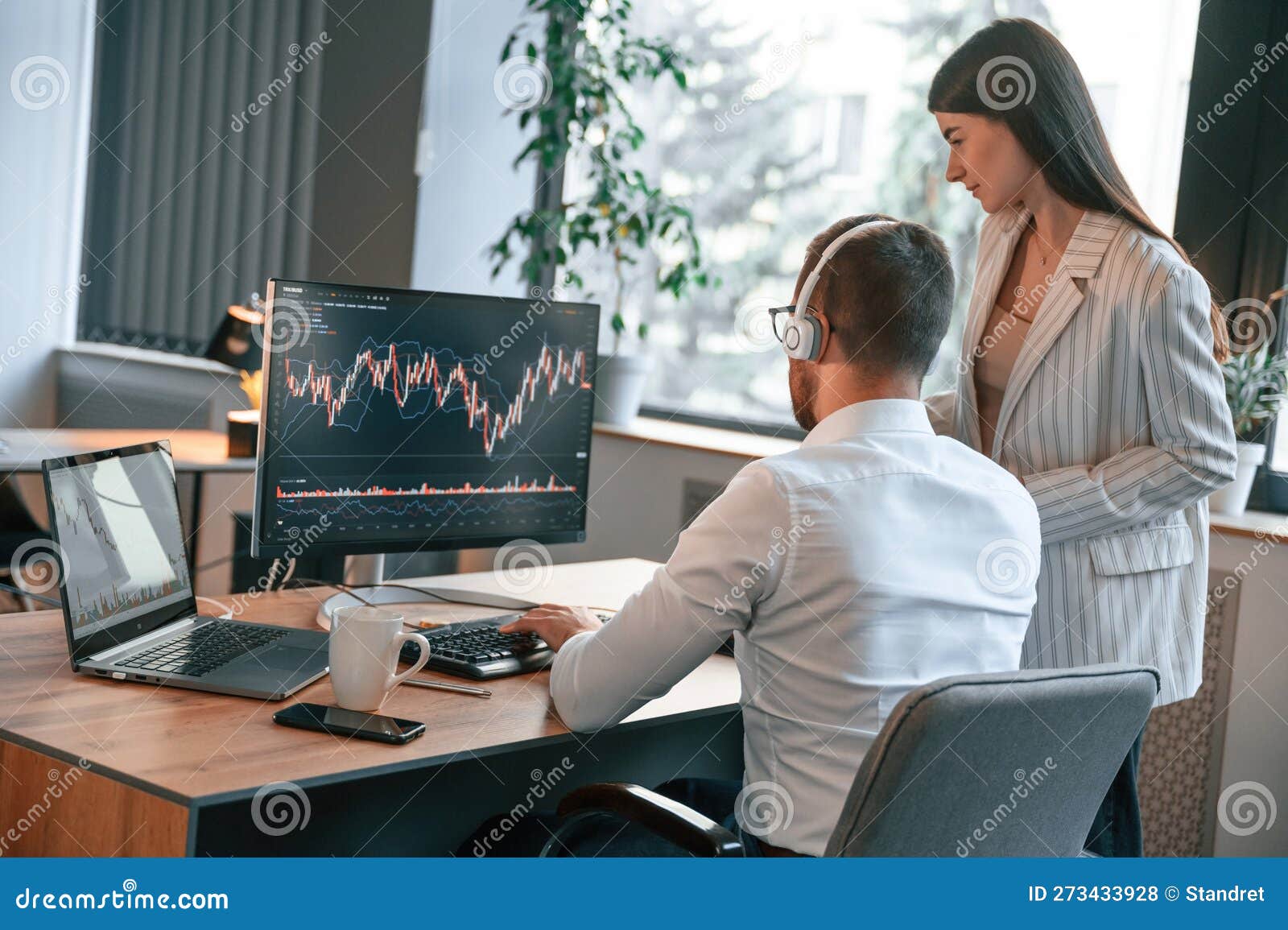 Two Office Workers are Analyzing Graphs that on the Computer Screen ...