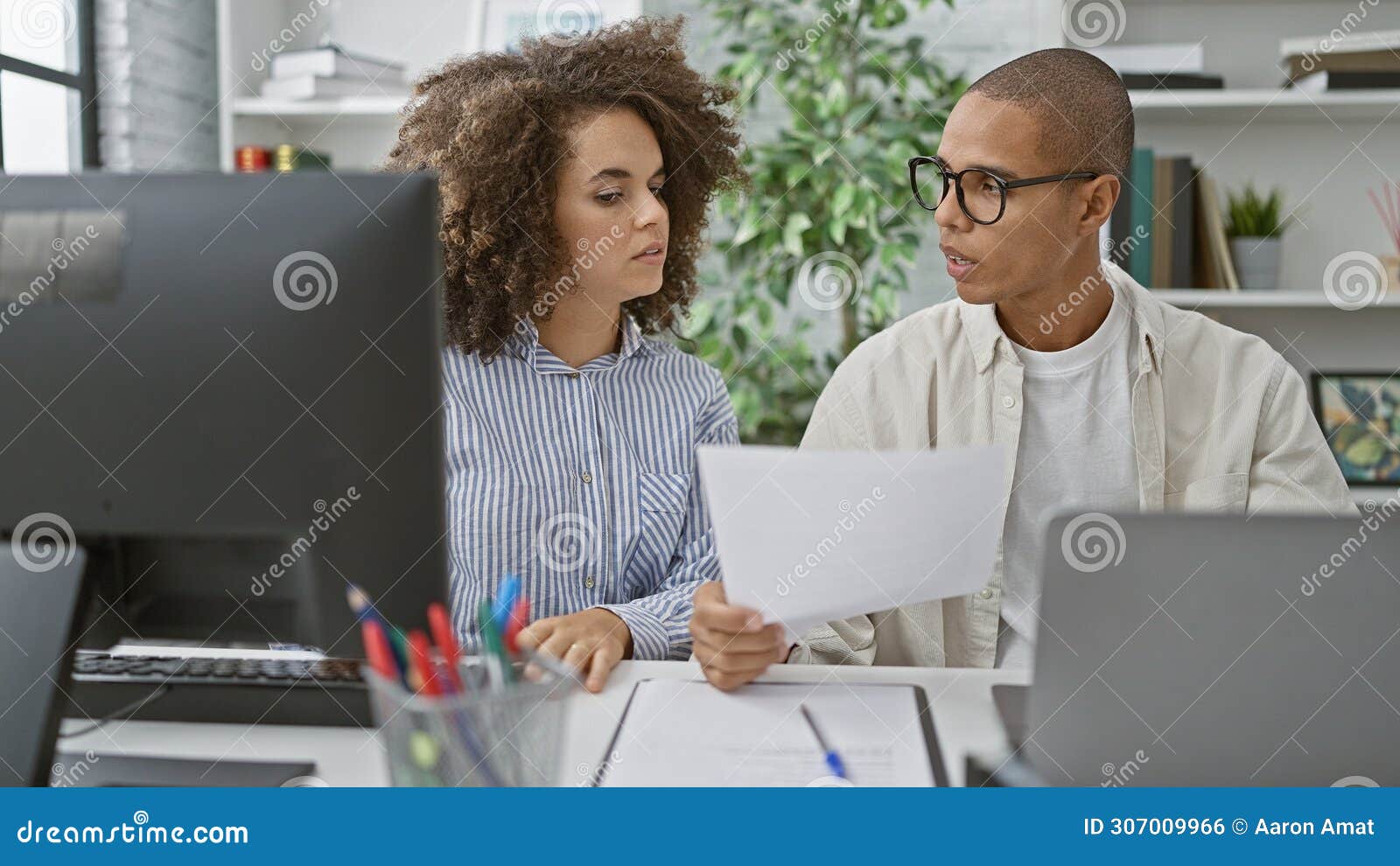 Two Office Workers, Man and Woman, Work Together Using Computer and ...