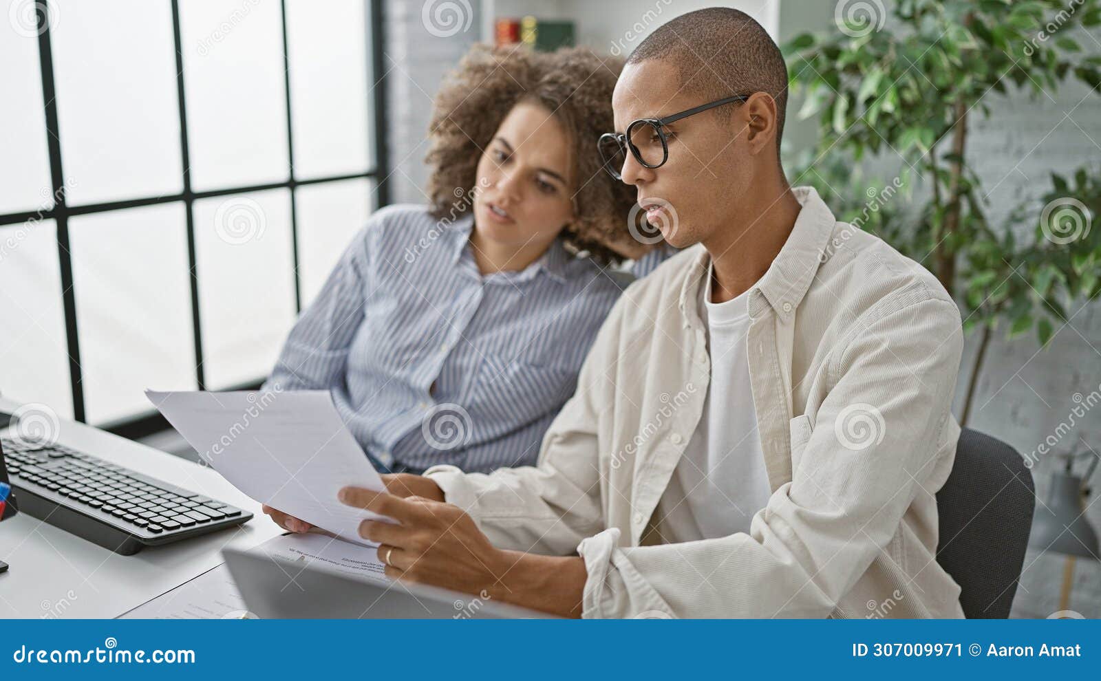 Two Office Workers, Man and Woman, Work Together Using Computer and ...