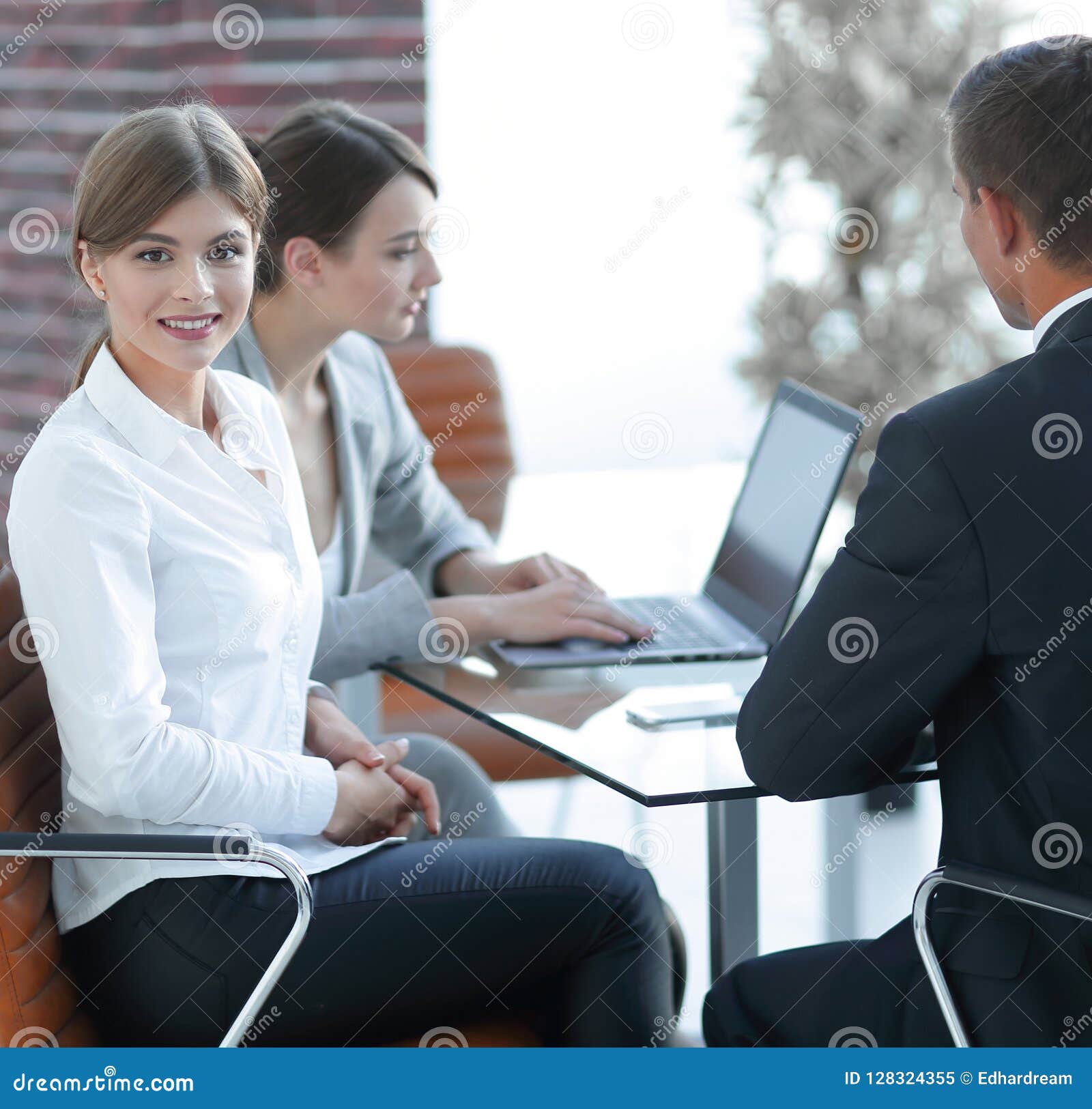 Office Workers Sitting Behind a Desk. Stock Image - Image of assistant ...