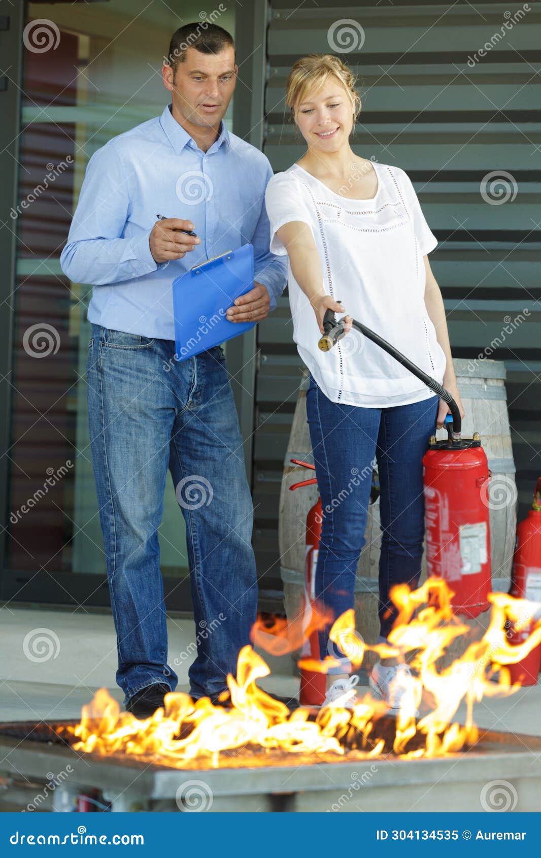 Two Officer Using Fire Extinguisher in Fire Fighting Training Stock ...