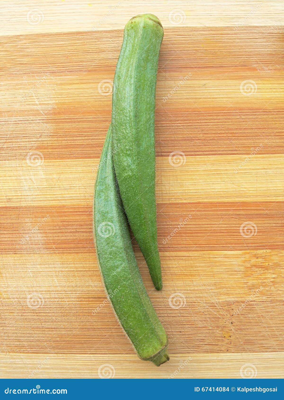Two Okra on Wooden Background Stock Photo - Image of frame, fingers ...