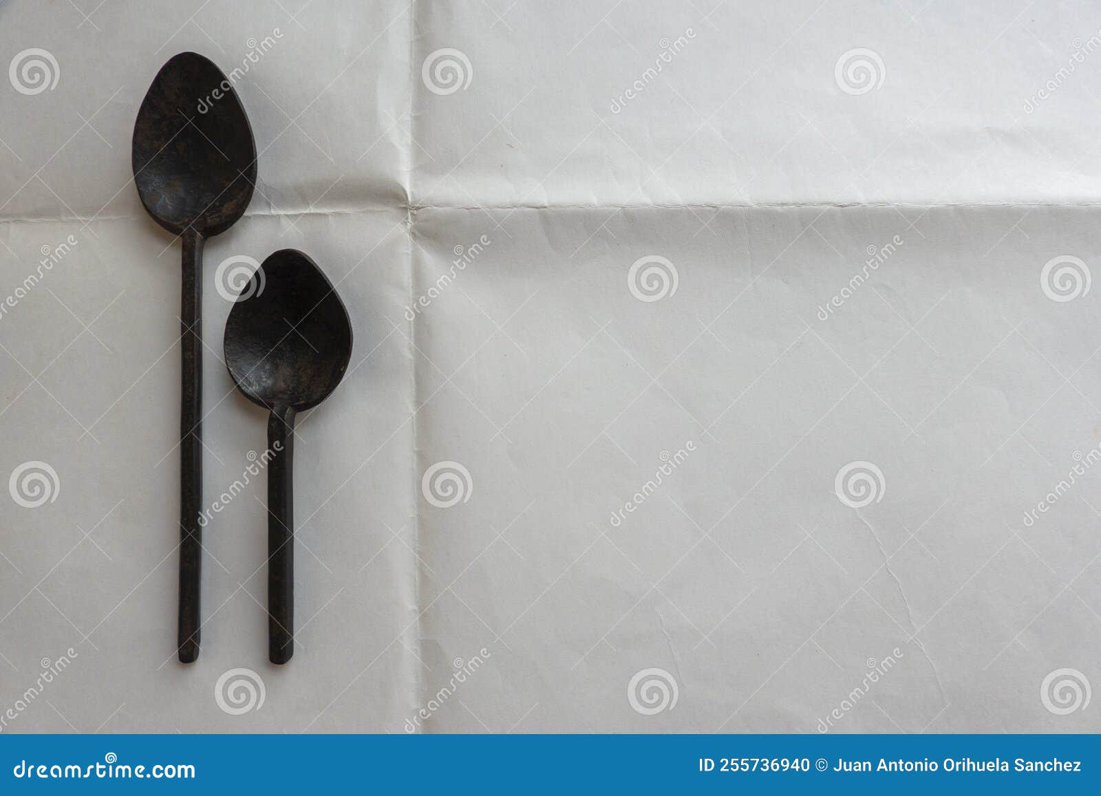 Two Old Iron Spoons on White Background with a Copy Space on the Right ...