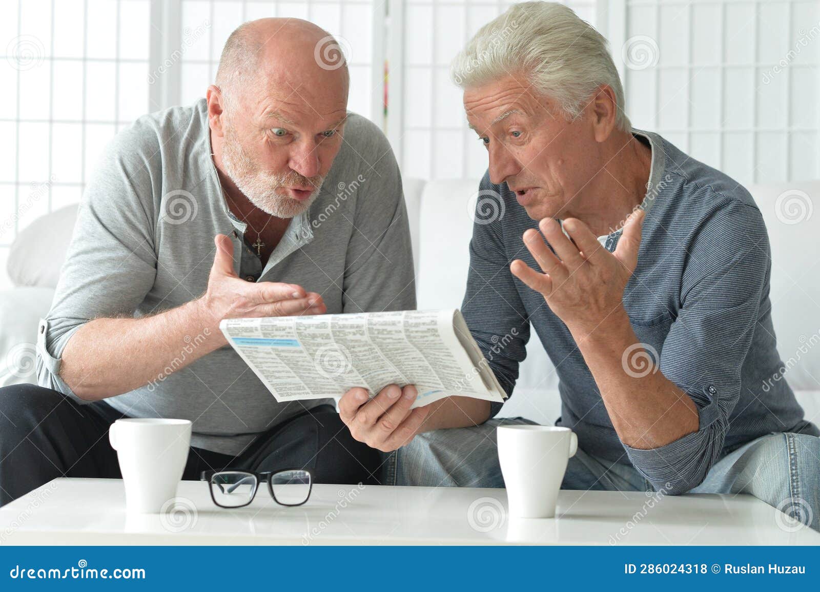 Two Old Men Sitting at Table and Discussing News Stock Photo - Image of ...