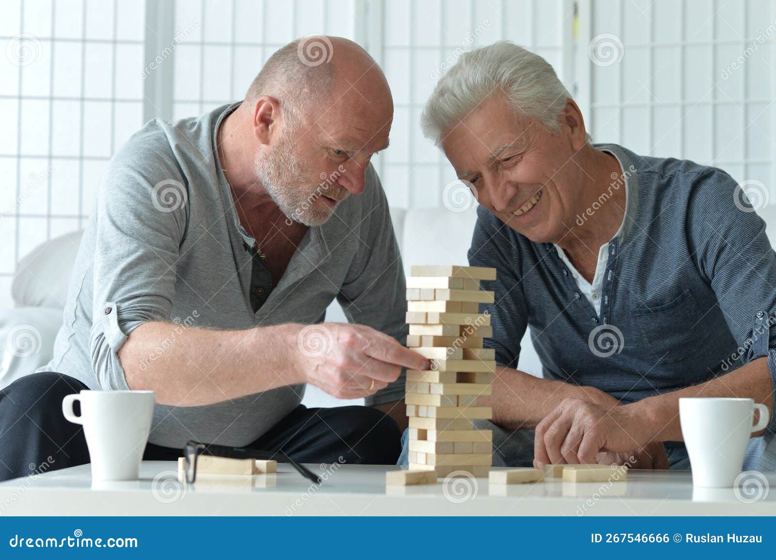 Two Old Men Sitting at Table and Playing with Wooden Blocks Stock Photo ...