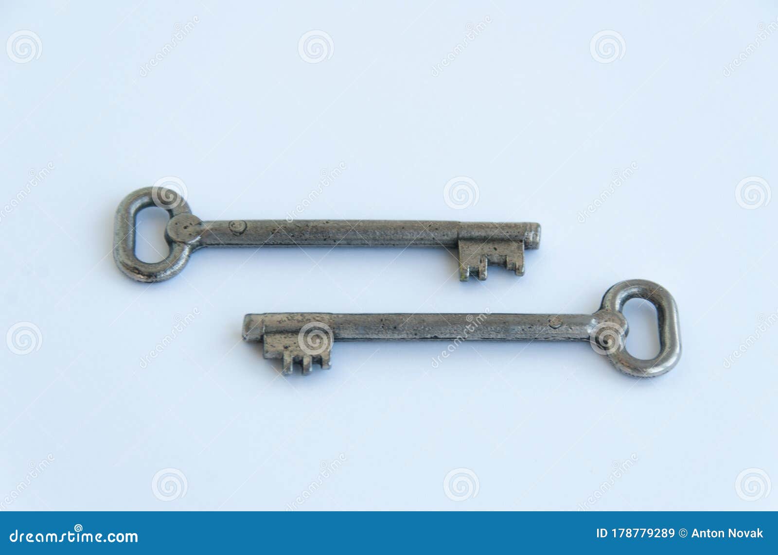 Two Old Silver Keys Lying Parallel To Each Other on White Background ...