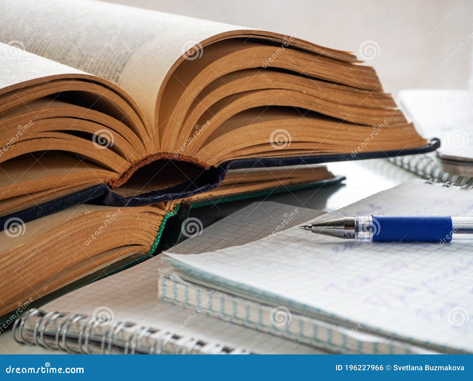 Two Old Thick Books are on the Table, One on Top of the Other. Nearby ...