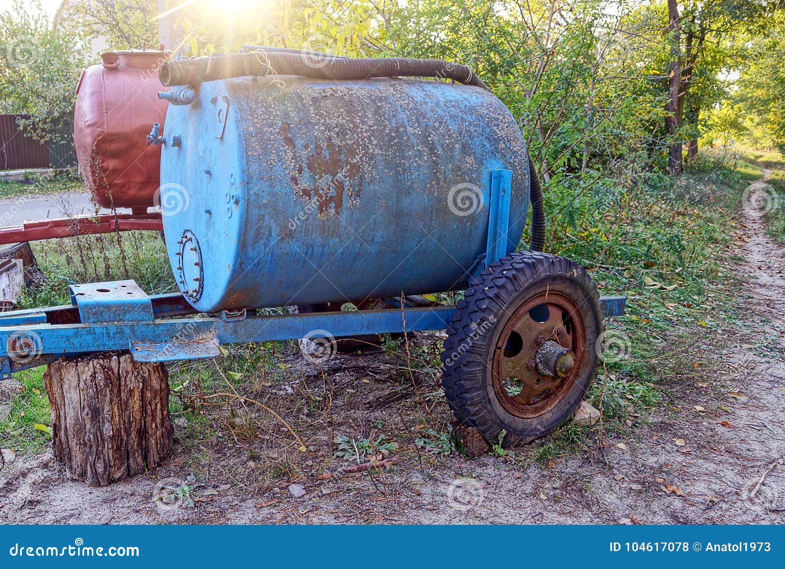 Two Old Rusty Barrels on Wheels on the Street Stock Photo - Image of ...