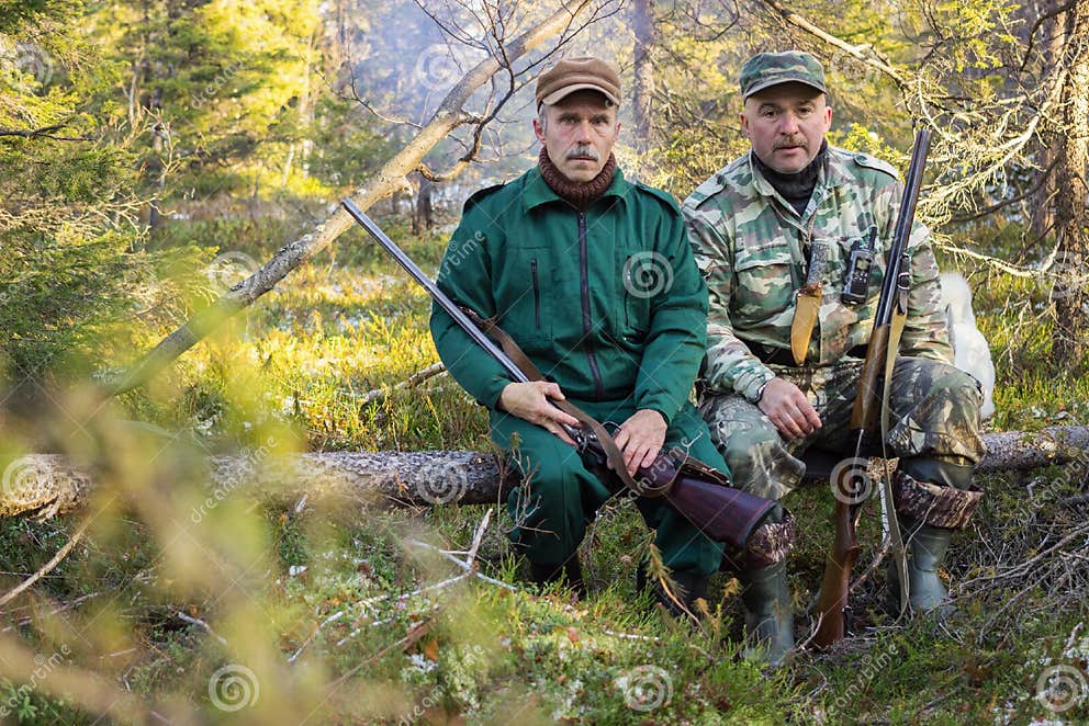 Two older hunters rest stock photo. Image of resting - 46313714