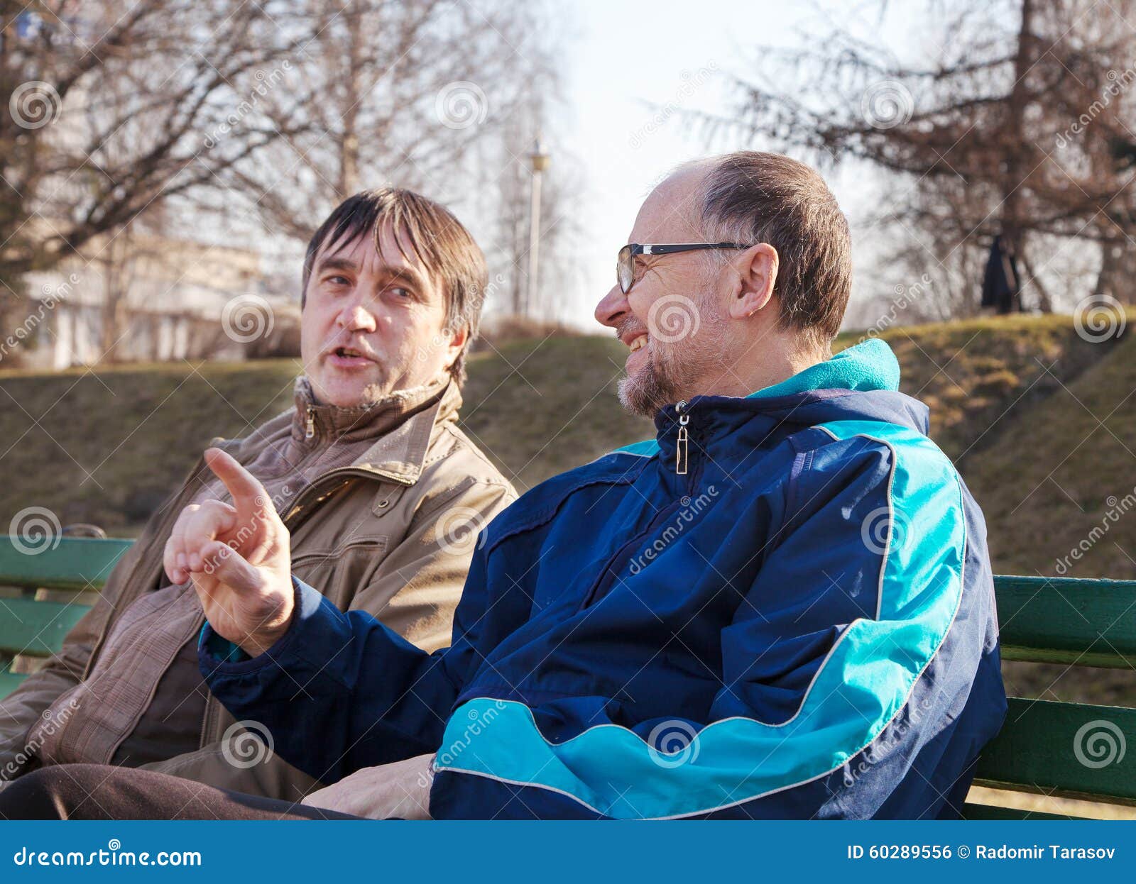Two Older Men Talk on a Park Bench Stock Photo - Image of outdoors ...