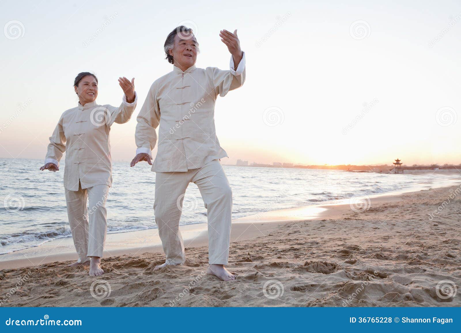 Two Older People Practicing Taijiquan on the Beach at Sunset, China ...
