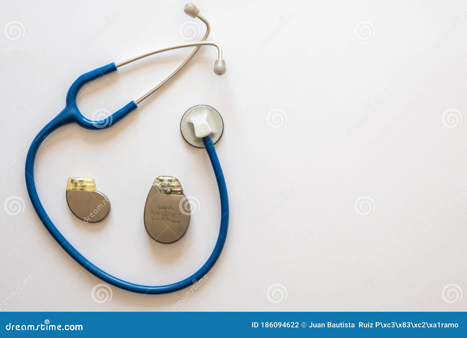 TWO PACEMAKER BATTERIES SURROUNDED by a BLUE STETHOSCOPE Stock Photo ...