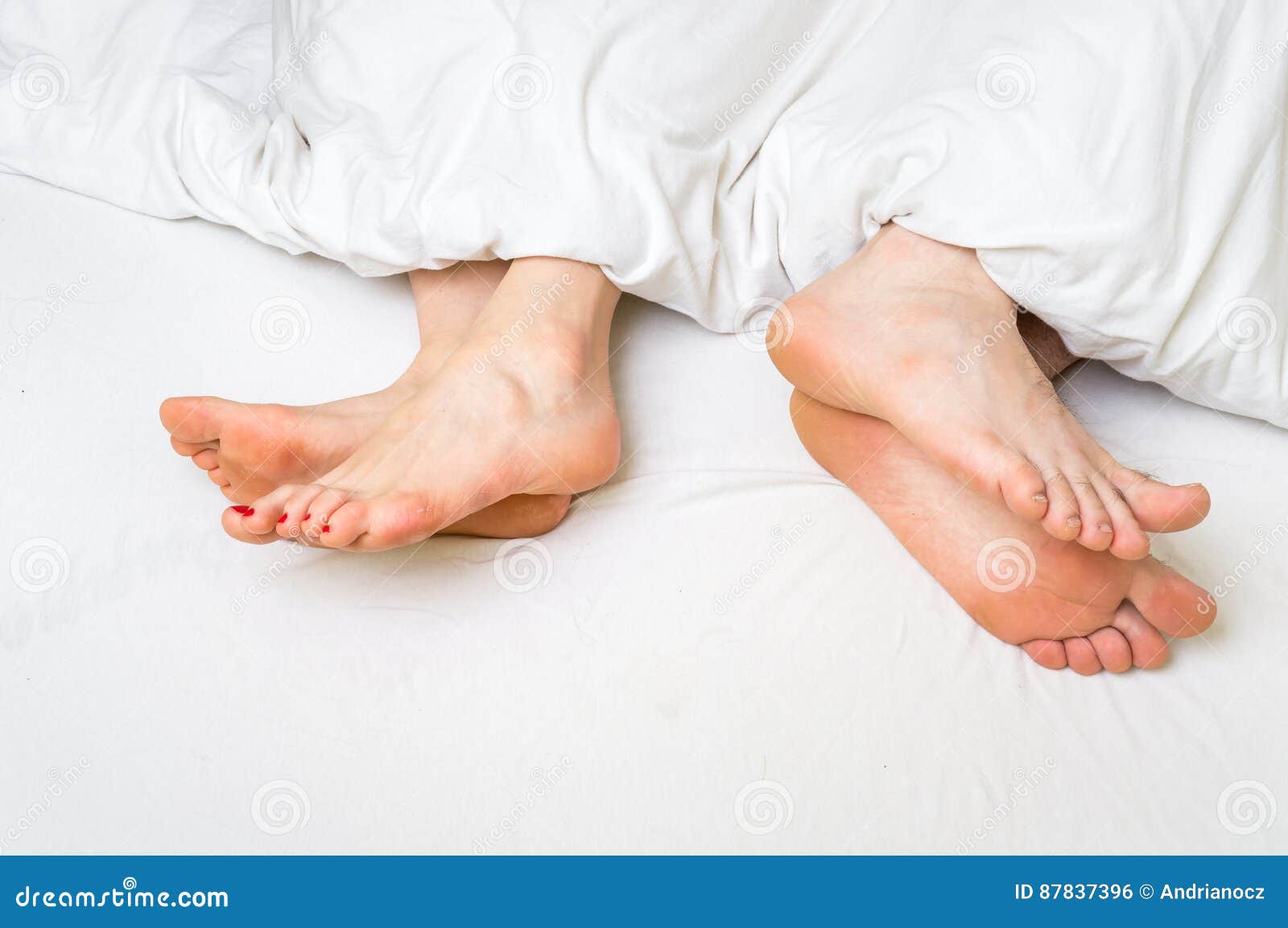 Two Pair of Feet Far from Each Other in a Bed Stock Photo - Image of ...