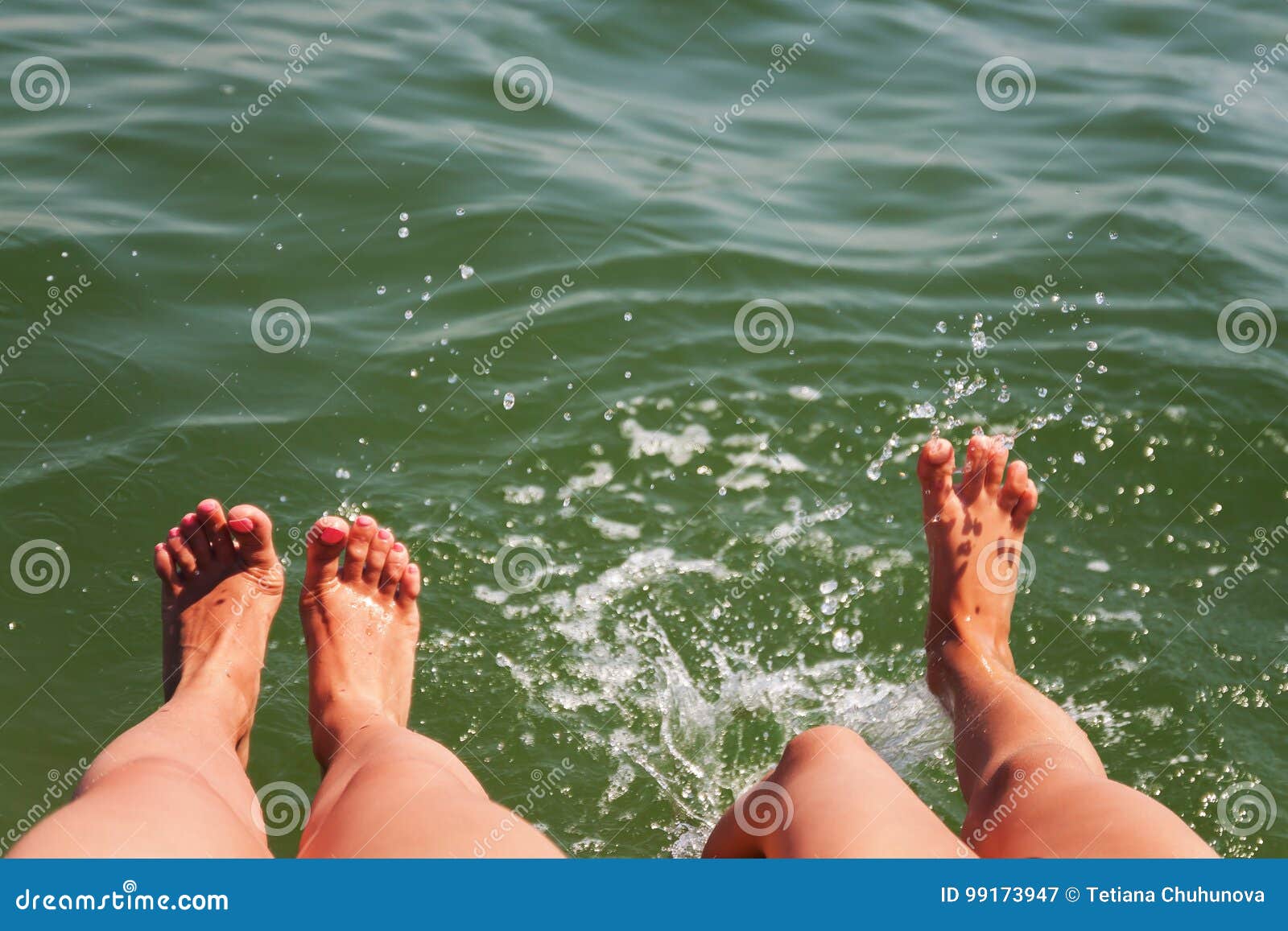 Two Pairs of Feet Splash in the Water Stock Image - Image of person ...