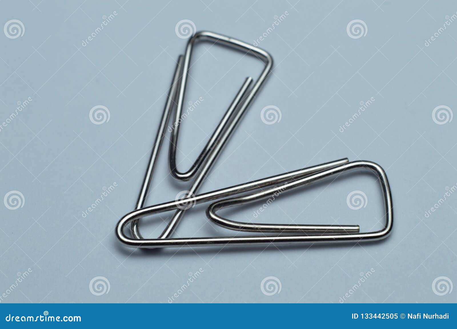 Two Paperclips Isolated on White Papers Stock Image - Image of ...