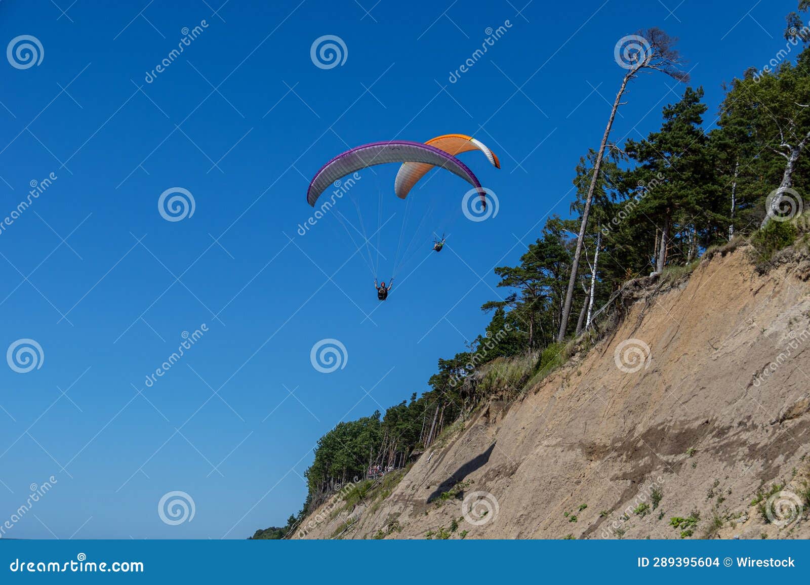 Two Paragliders Next To a Sloping Cliff Stock Photo - Image of slope ...